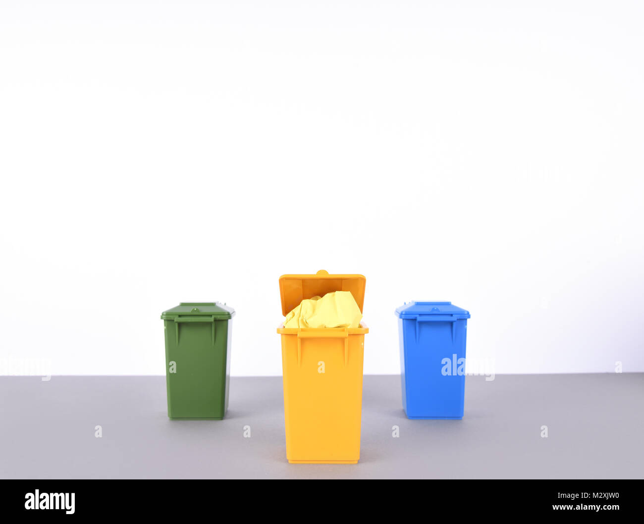 Colorful recycle bins on white and gray background. Recycling concept ...
