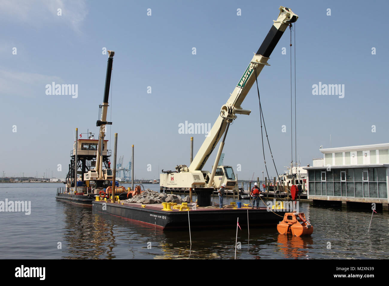 The Corps vessel Elizabeth and its barge offload 30 tons of material ...