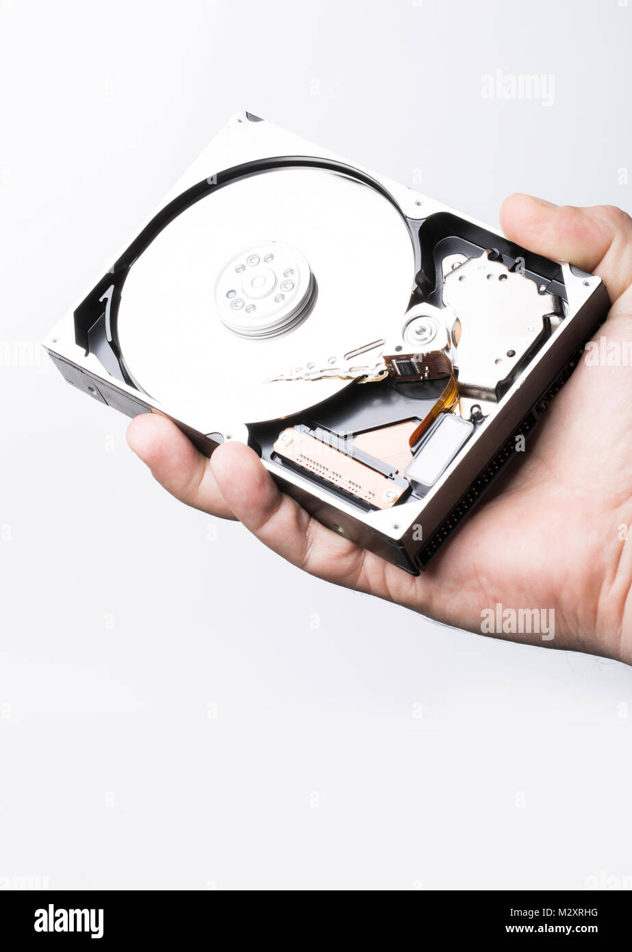 Disassembled hard disk drive in male hand on white background Stock ...