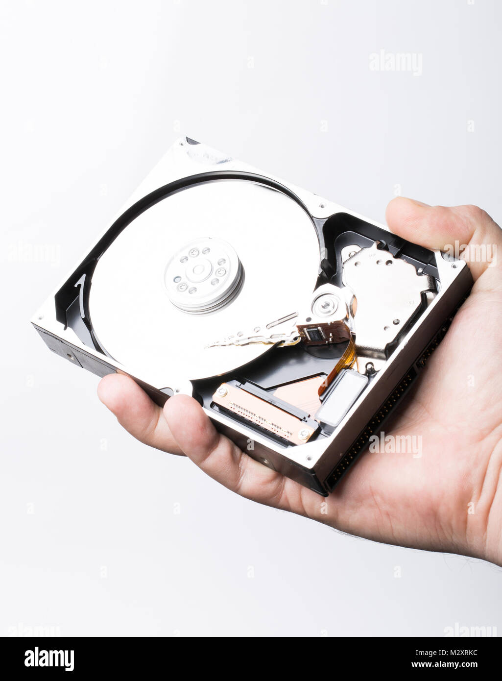 Disassembled hard disk drive in male hand on white background Stock ...