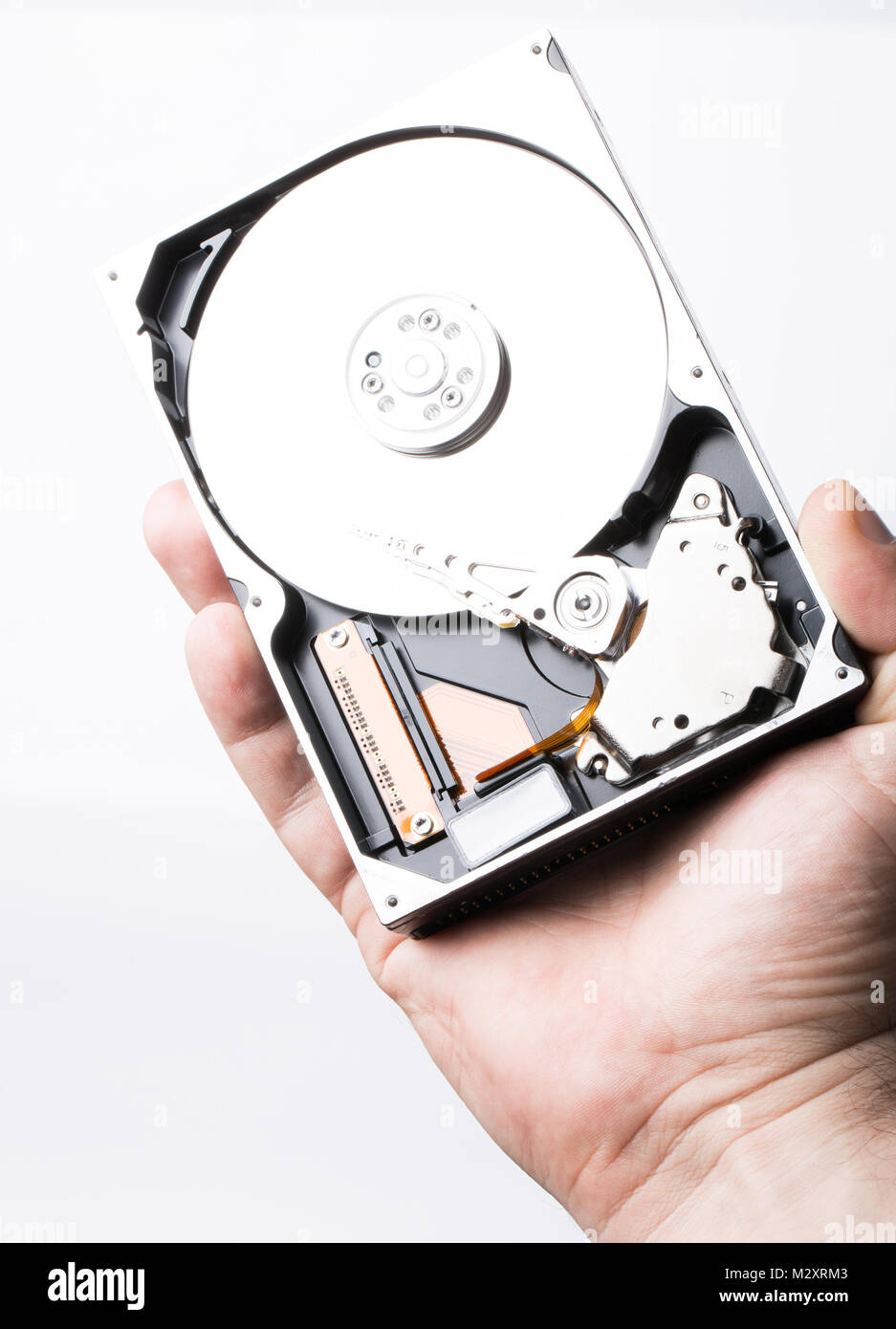 Disassembled hard disk drive in male hand on white background Stock ...