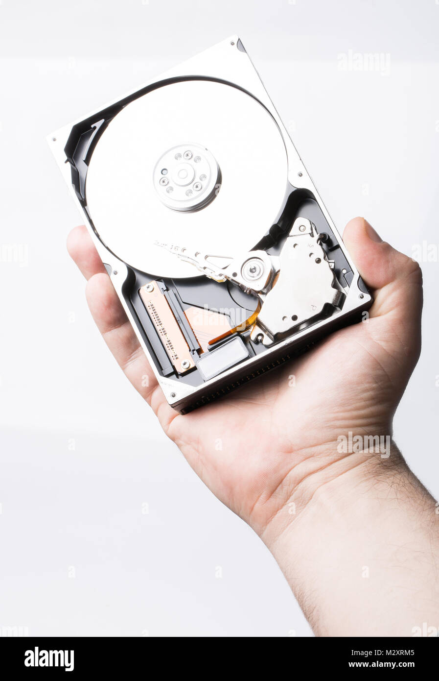 Disassembled hard disk drive in male hand on white background Stock ...