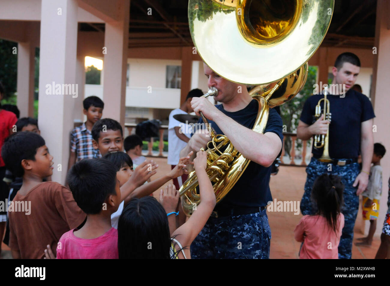 U.S. 7th Fleet band, performs a tuba for Cambodian children during a ...