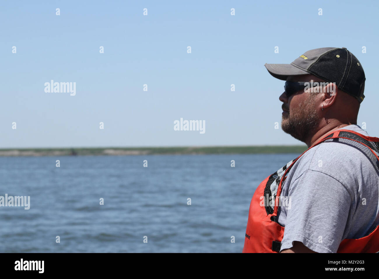 NORFOLK -- James Jarrell, a deckhand for the Corps vessel Harrel, scans ...
