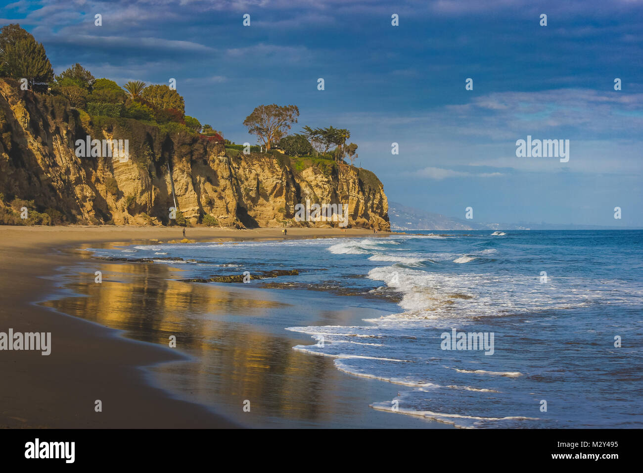 Beachside view of beautiful blue Pacific Ocean and stunning cliffs ...
