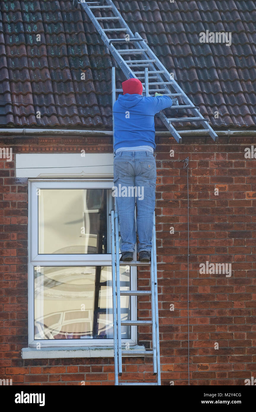 Man climbing window hi-res stock photography and images - Alamy