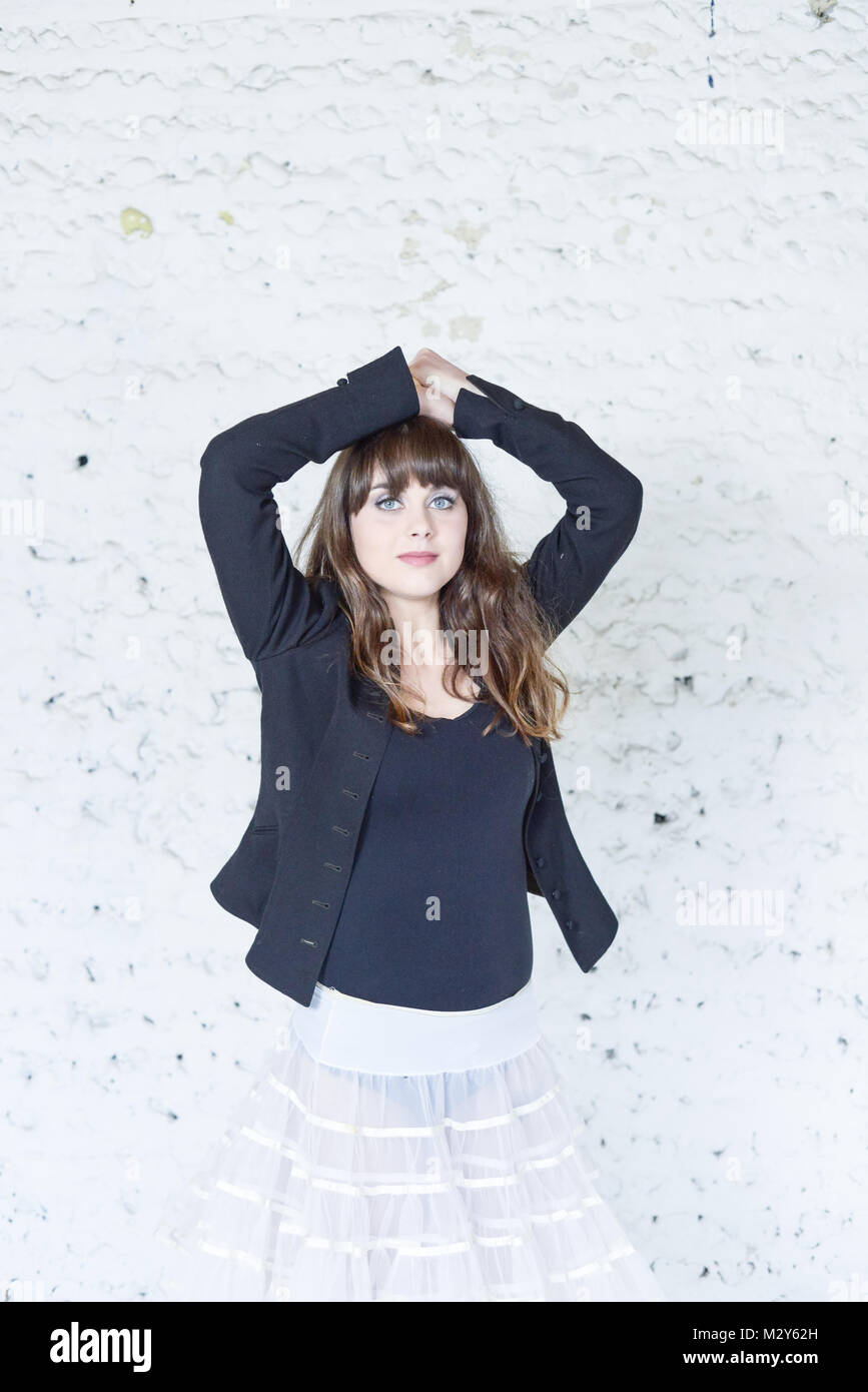Emotionless Girl moving around a room on a white background, she is ...