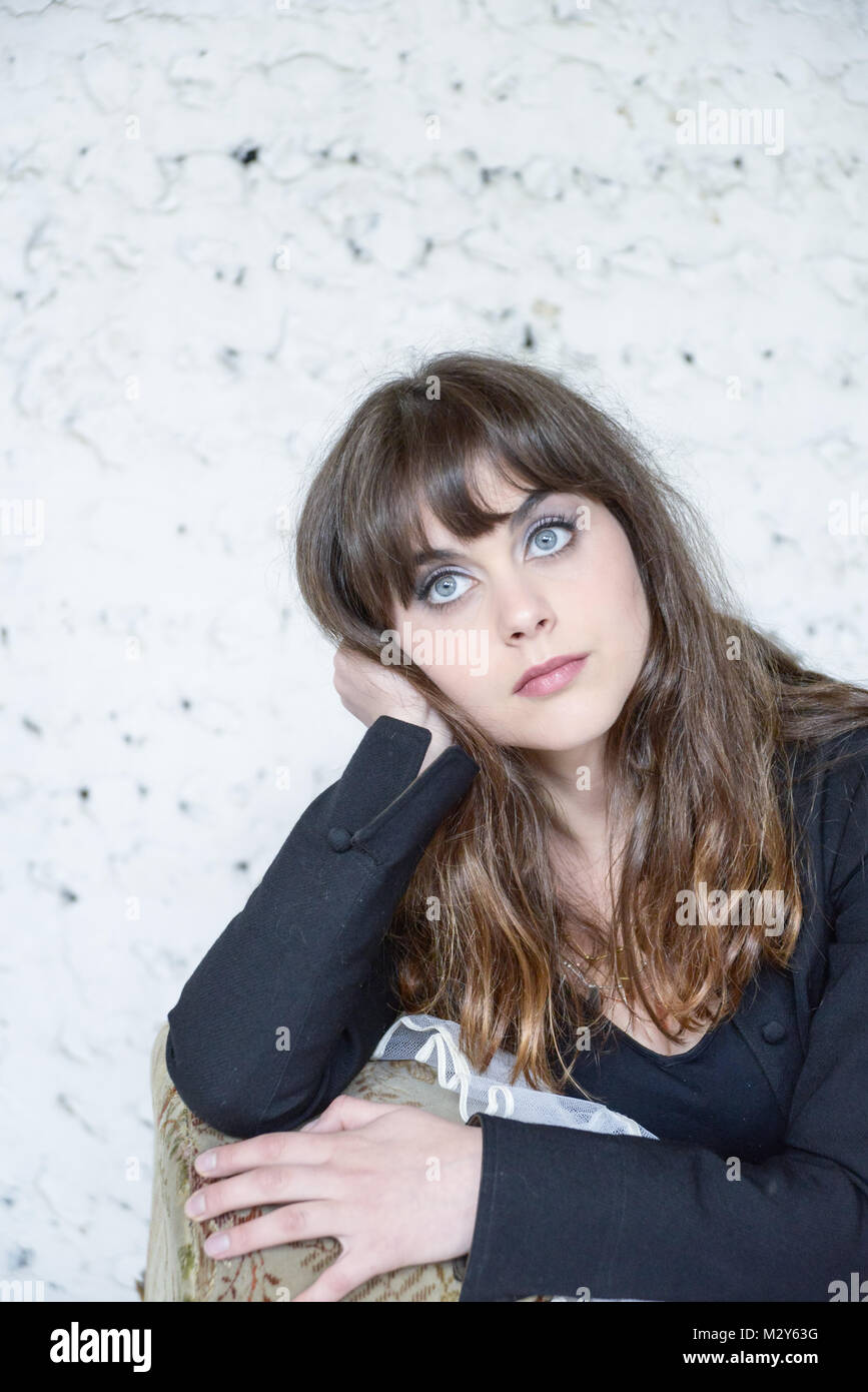 Emotionless Girl moving around a room on a white background, she is ...
