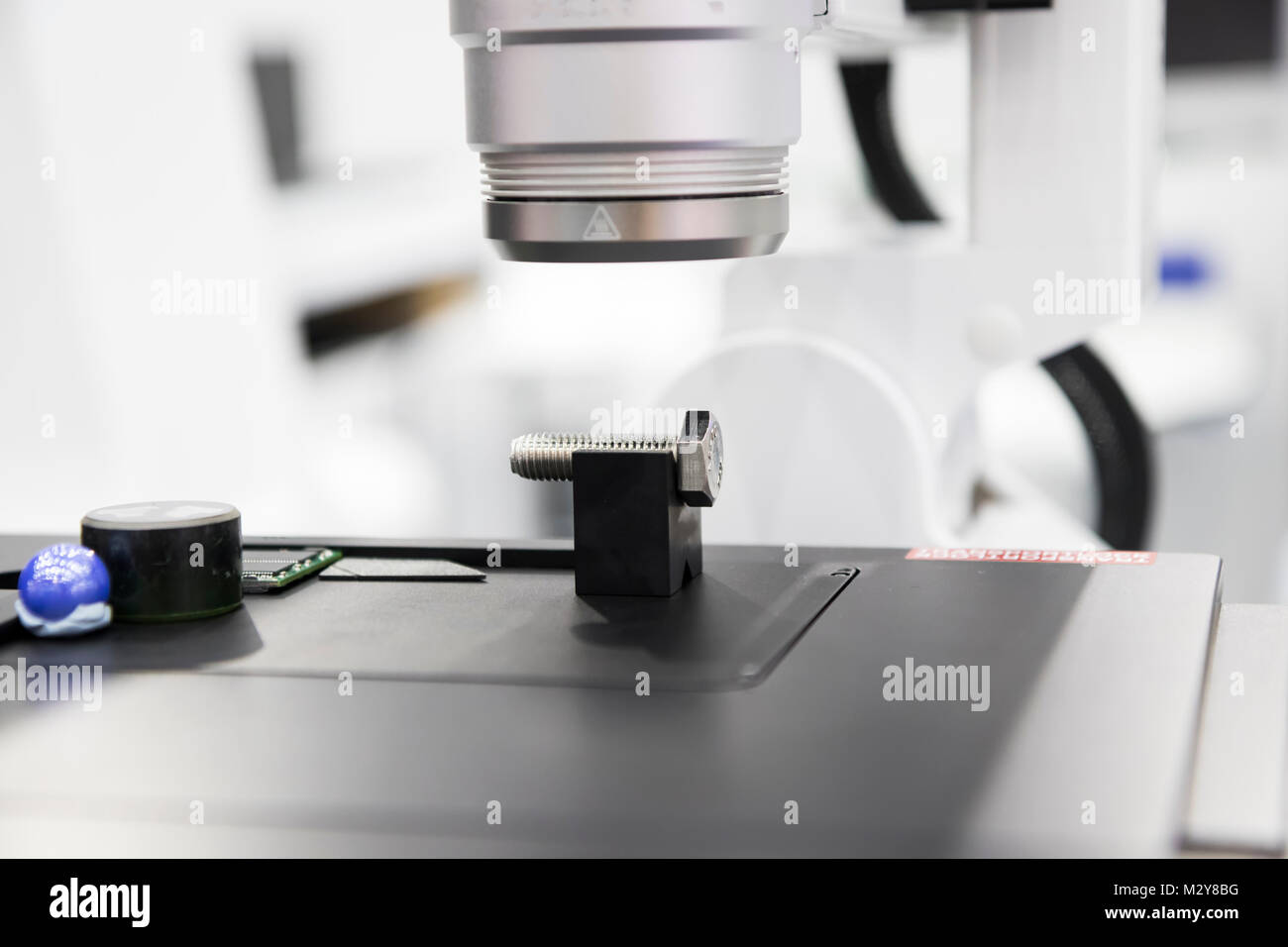 Bolt inspected by microscope ; quality control Stock Photo - Alamy