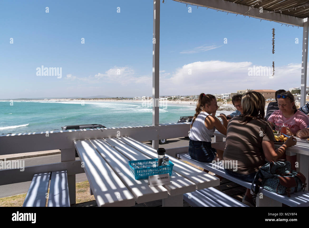 Family having lunch at a beachside restaurant at Yzerfontein along the ...