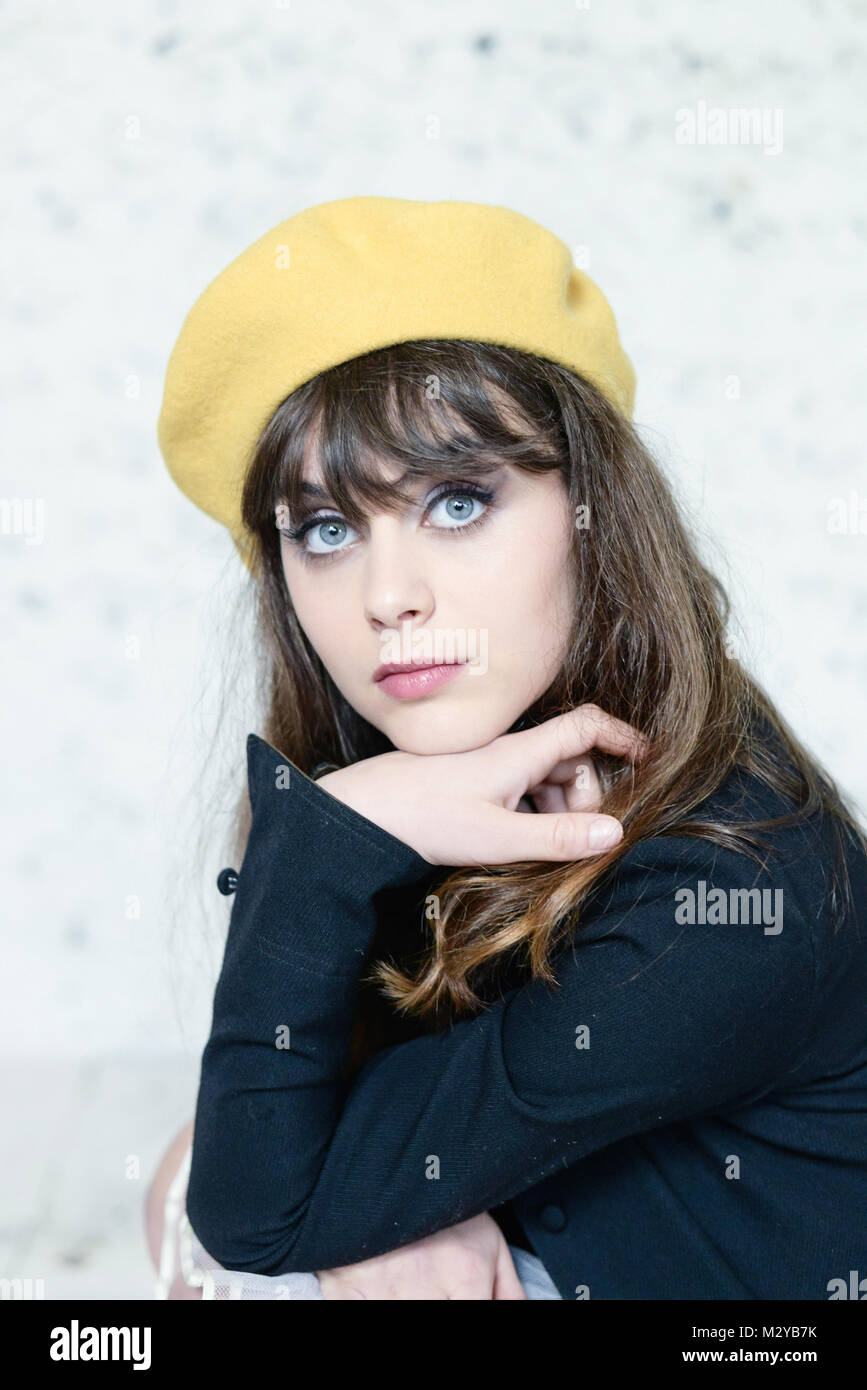 Emotionless Girl moving around a room on a white background, she is ...
