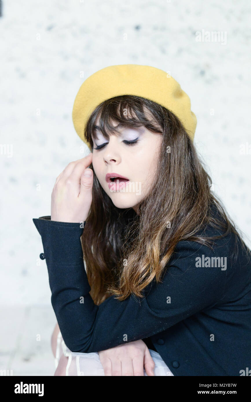 Emotionless Girl moving around a room on a white background, she is ...