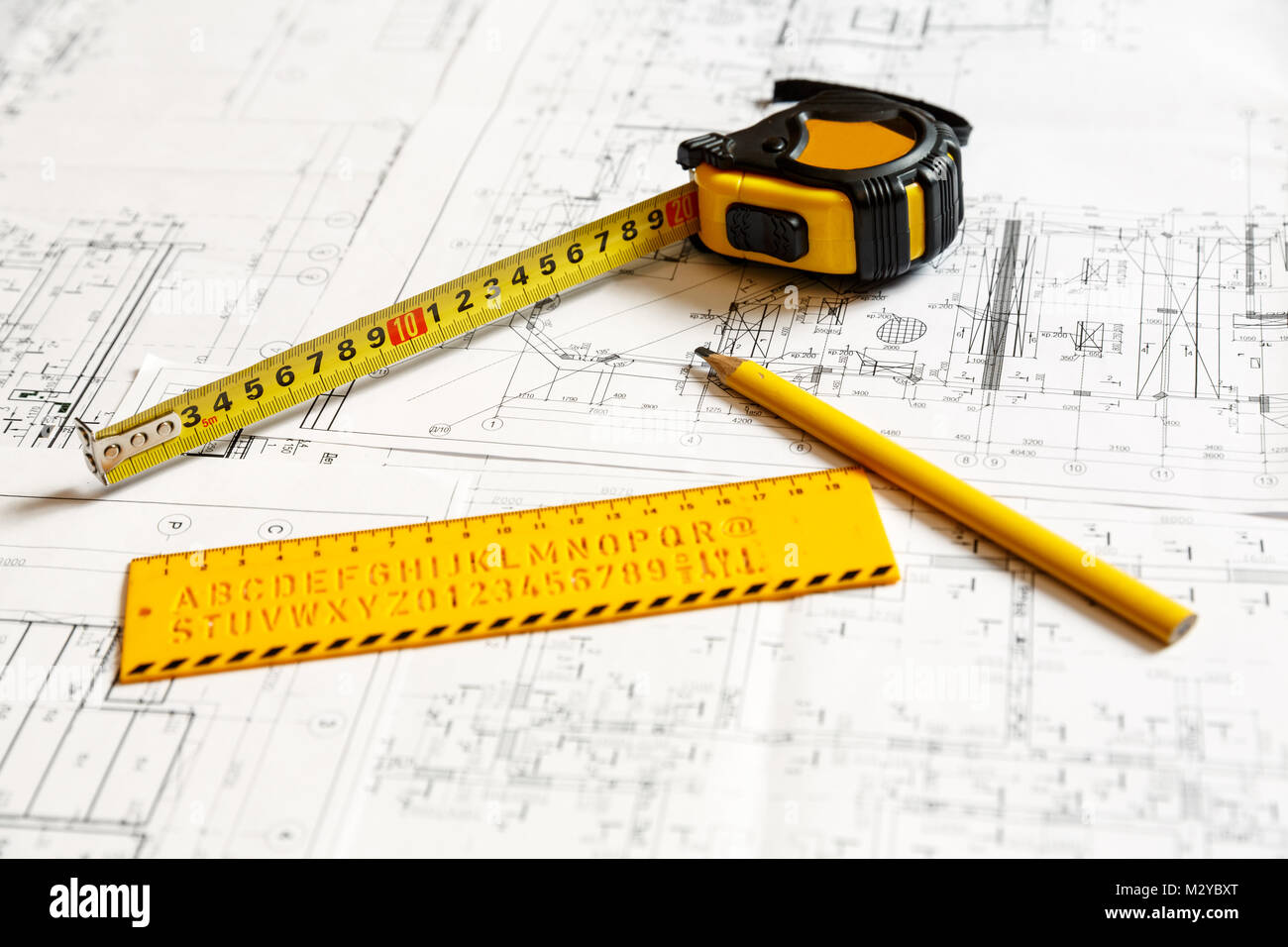 Image of a yellow ruler, yellow pencil and a collapsible ruler on ...