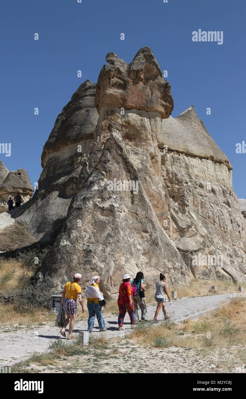 Tourists visiting some of the famous Fairy chimneys in Cappadocia which ...