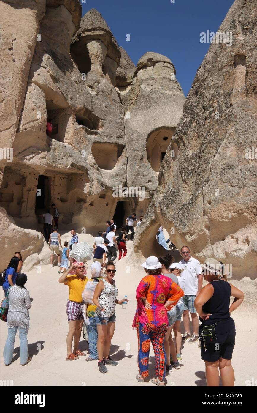 Tourists visiting some of the famous Fairy chimneys in Cappadocia which ...