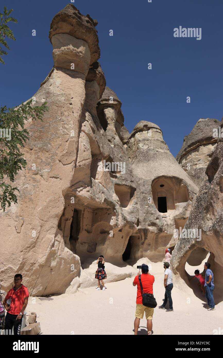 Tourists visiting some of the famous Fairy chimneys in Cappadocia which ...