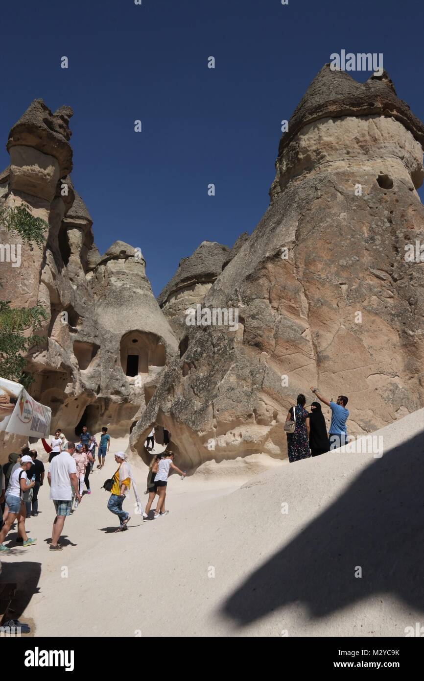 Tourists visiting some of the famous Fairy chimneys in Cappadocia which ...