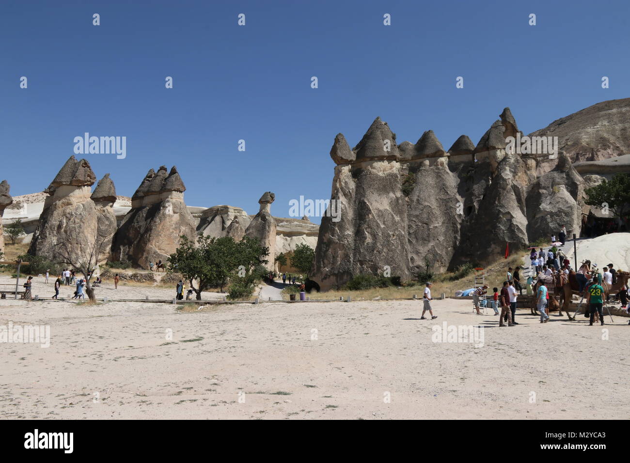 Tourists visiting some of the famous Fairy chimneys in Cappadocia which ...