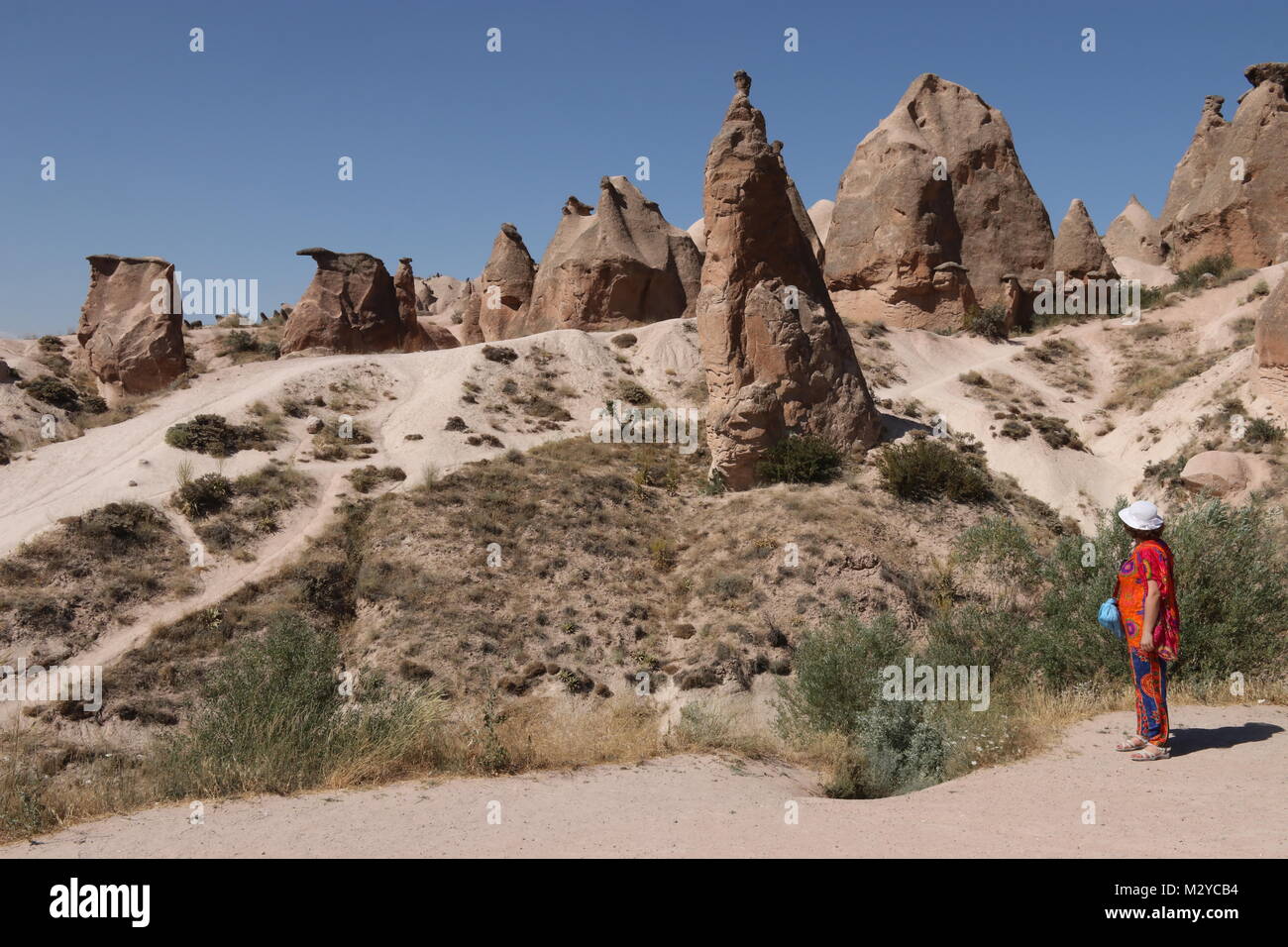 Tourists visiting some of the famous Fairy chimneys in Cappadocia which ...