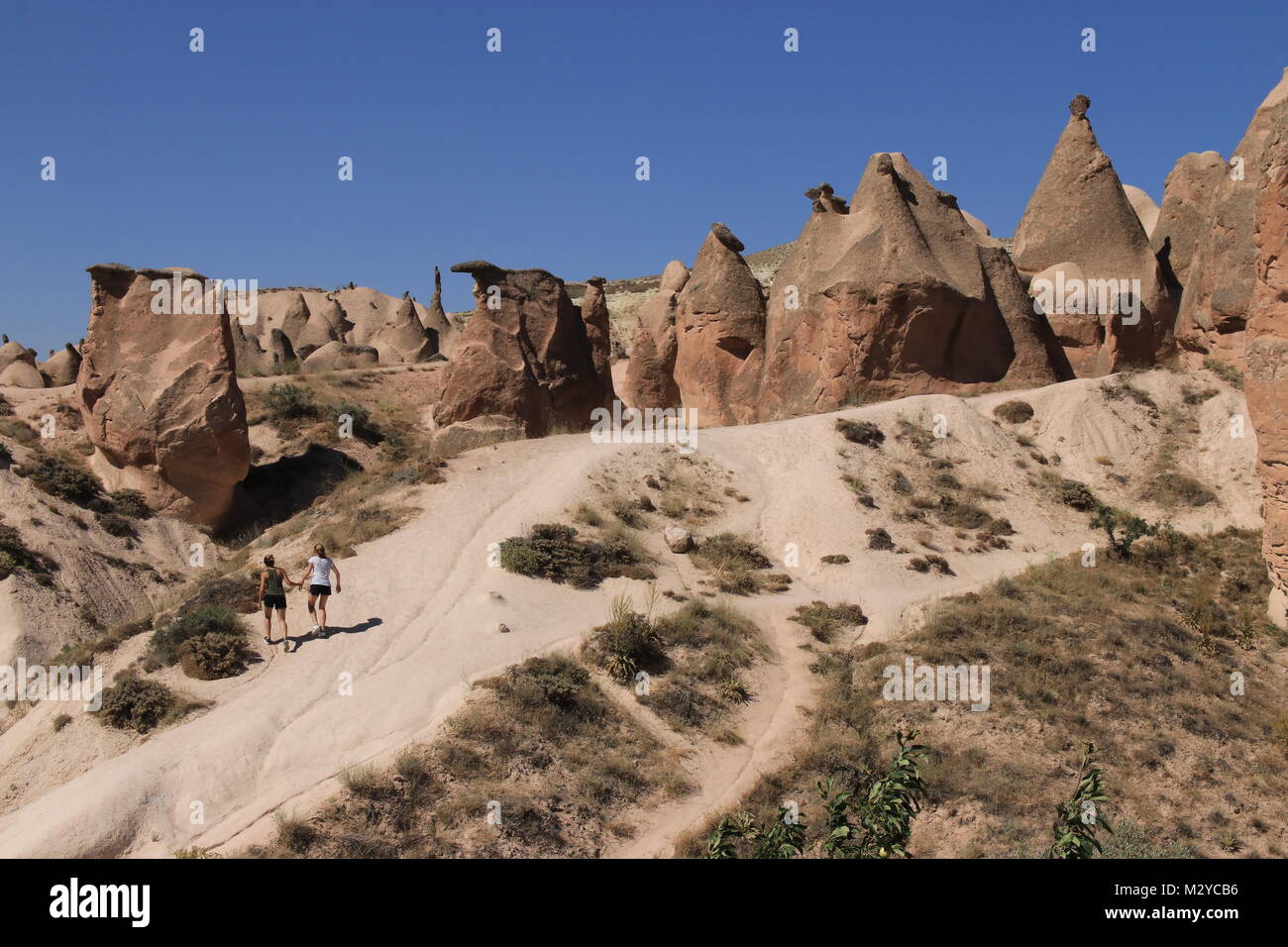 Tourists visiting some of the famous Fairy chimneys in Cappadocia which ...