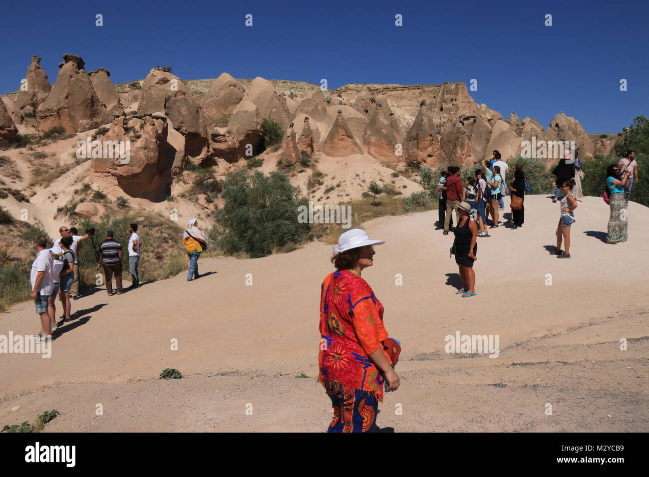 Tourists visiting some of the famous Fairy chimneys in Cappadocia which ...