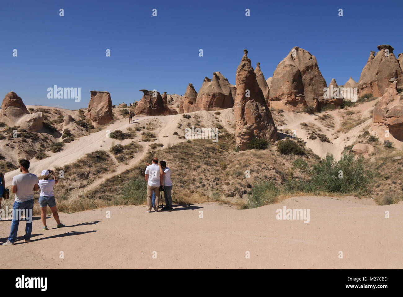 Tourists visiting some of the famous Fairy chimneys in Cappadocia which ...