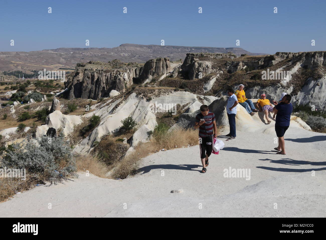 Tourists visiting some of the famous Fairy chimneys in Cappadocia which ...