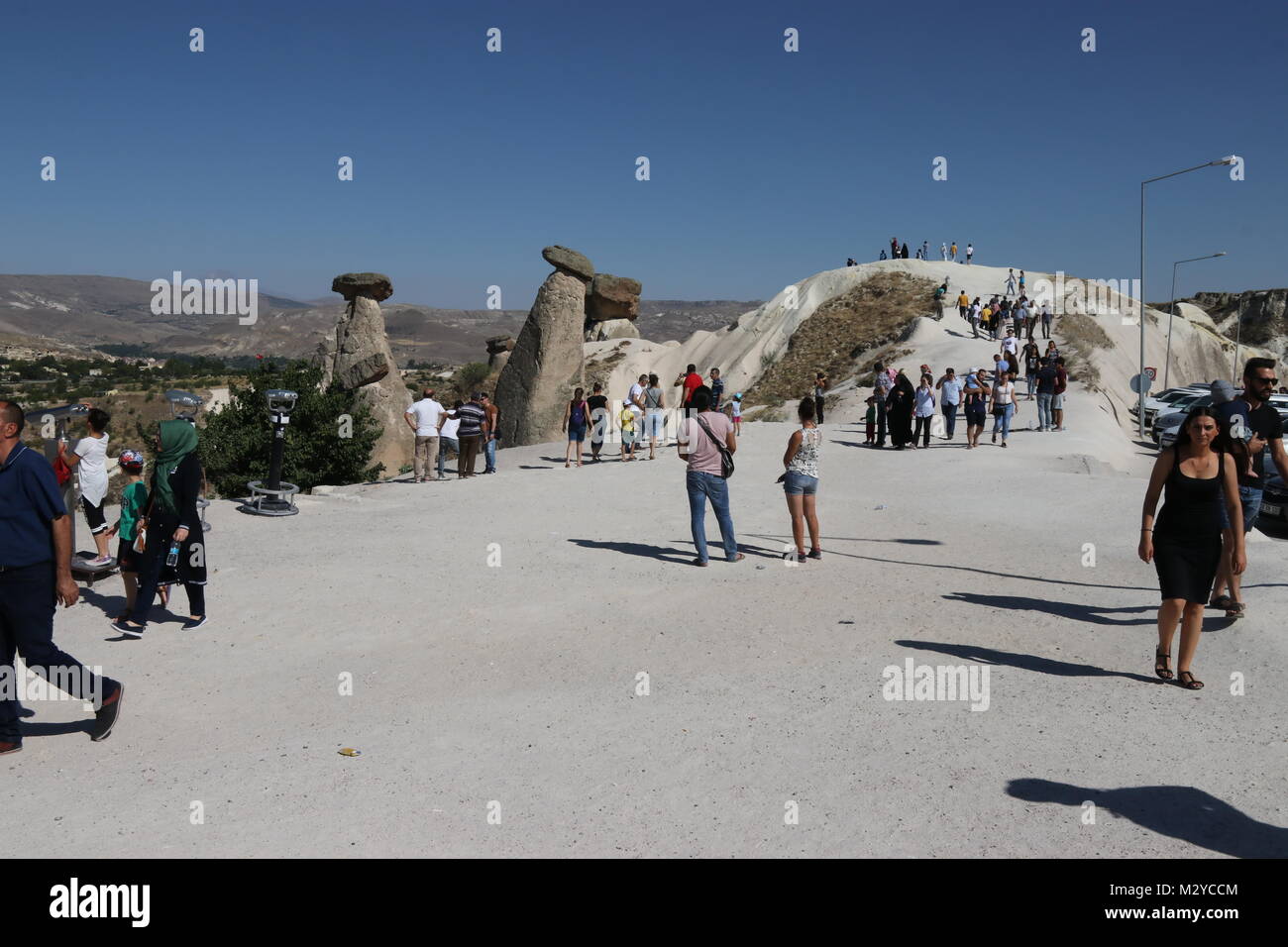 Tourists visiting some of the famous Fairy chimneys in Cappadocia which ...