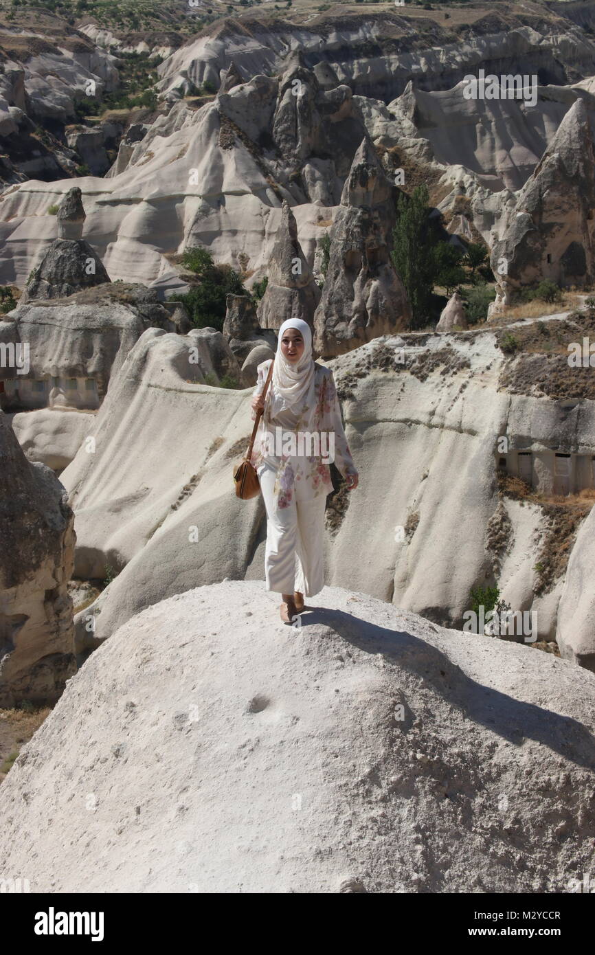 Tourists visiting some of the famous Fairy chimneys in Cappadocia which ...