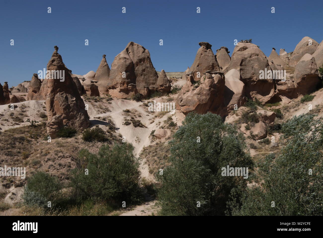 Tourists visiting some of the famous Fairy chimneys in Cappadocia which ...