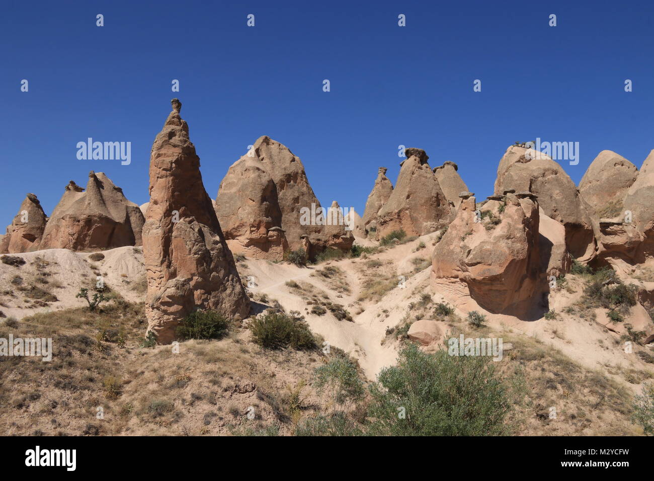 Tourists visiting some of the famous Fairy chimneys in Cappadocia which ...