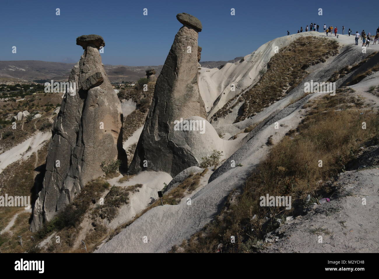 Tourists visiting some of the famous Fairy chimneys in Cappadocia which ...