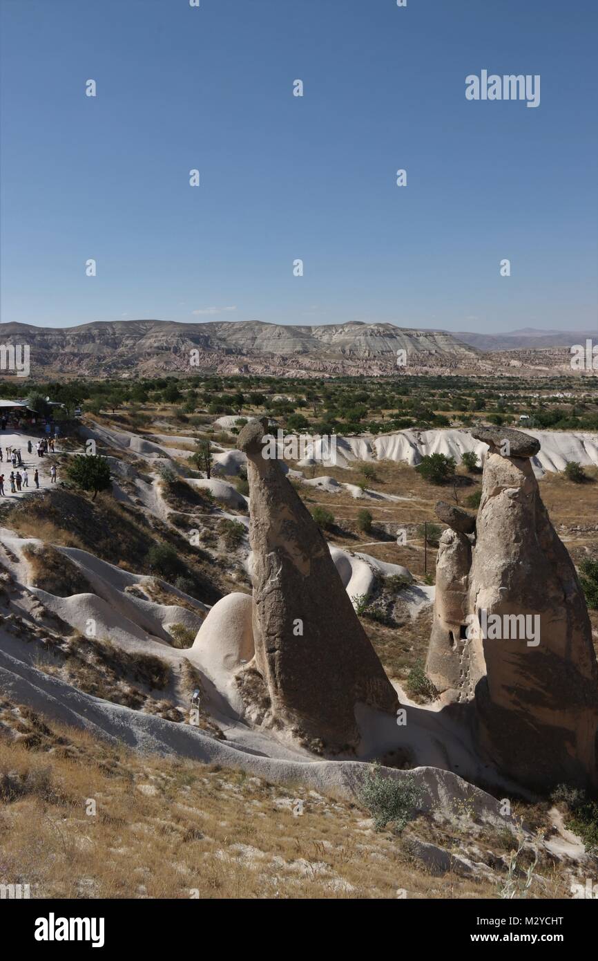 Tourists visiting some of the famous Fairy chimneys in Cappadocia which ...
