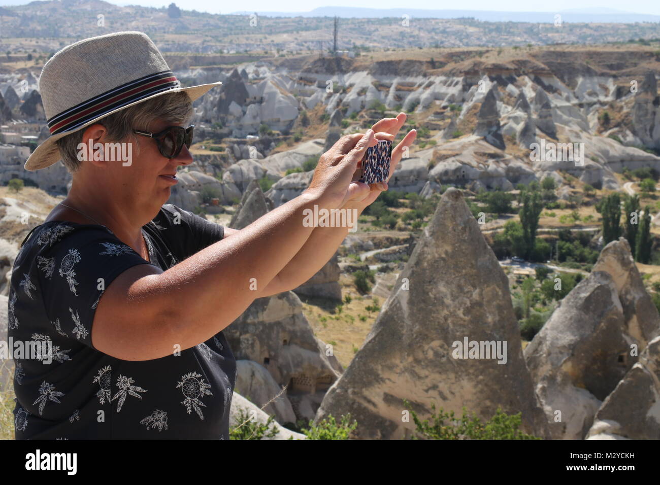 Tourists visiting some of the famous Fairy chimneys in Cappadocia which ...