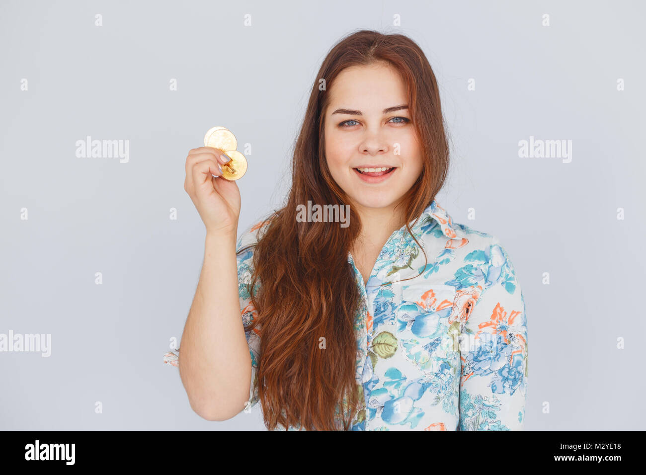 Happy young woman showing bitcoin, isolated Stock Photo - Alamy