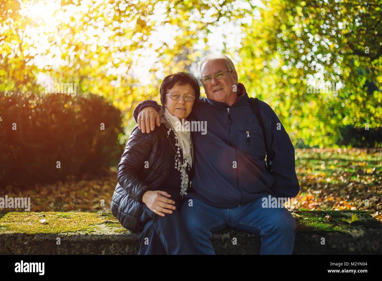 Senior couple enjoying time at the park at the sunset. Concerpt Family ...