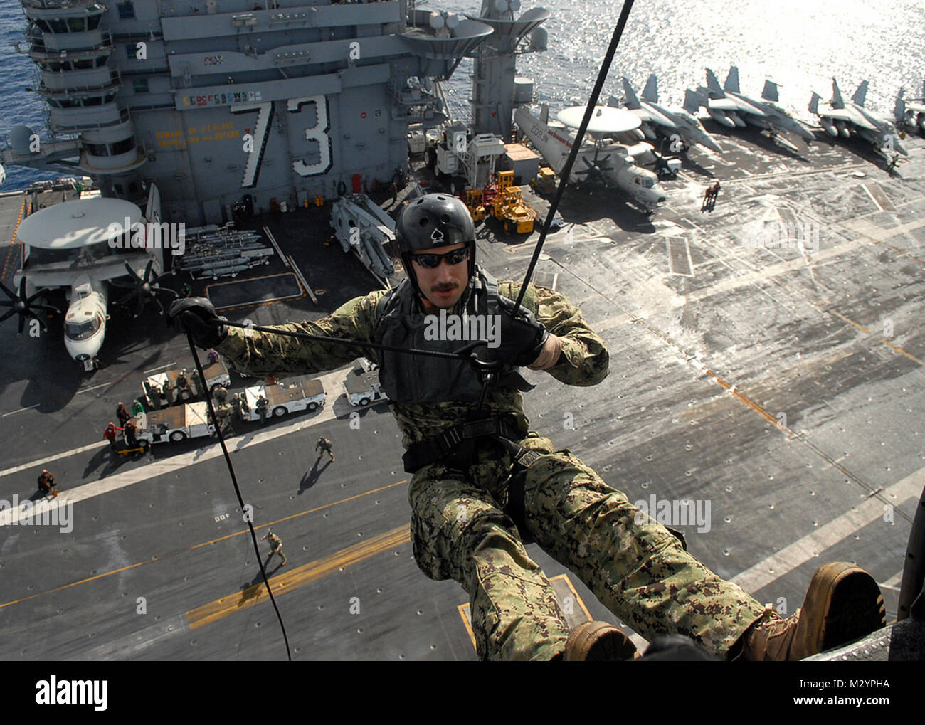Repels from an HH-60H Sea Hawk, from the Helicopter Anti-Submarine Squadron 14, onto the flight ...