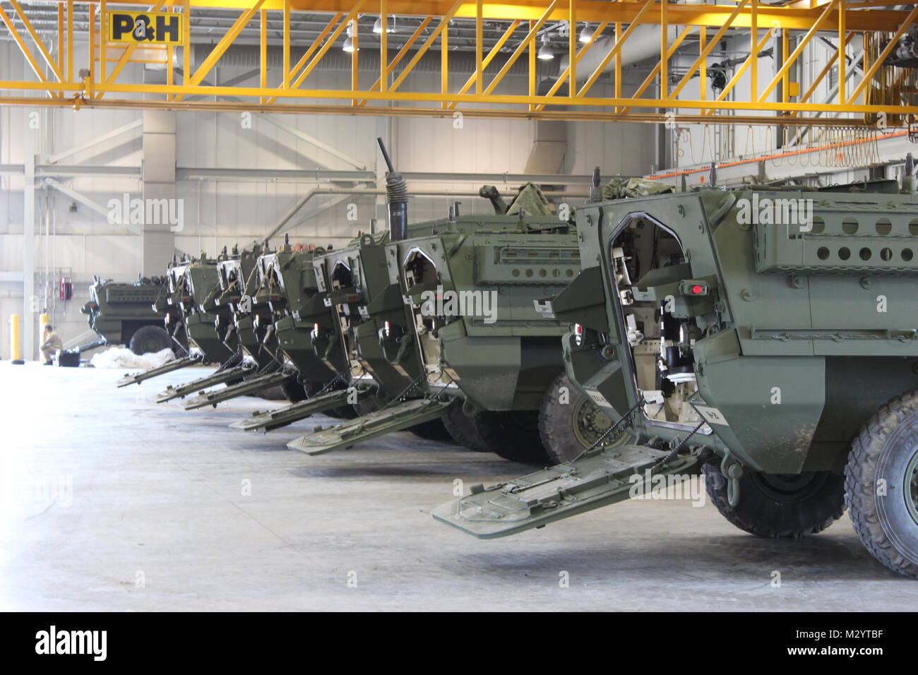 Strykers are lined up in Fort Wainwright’s Vehicle Maintenance Facility ...