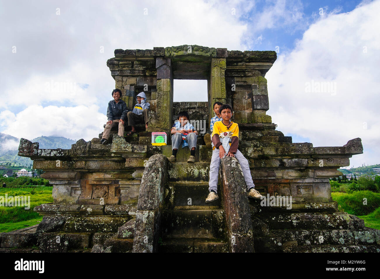 Young boys sitting in a temple of the Arjuna Hindu Dieng temple complex ...