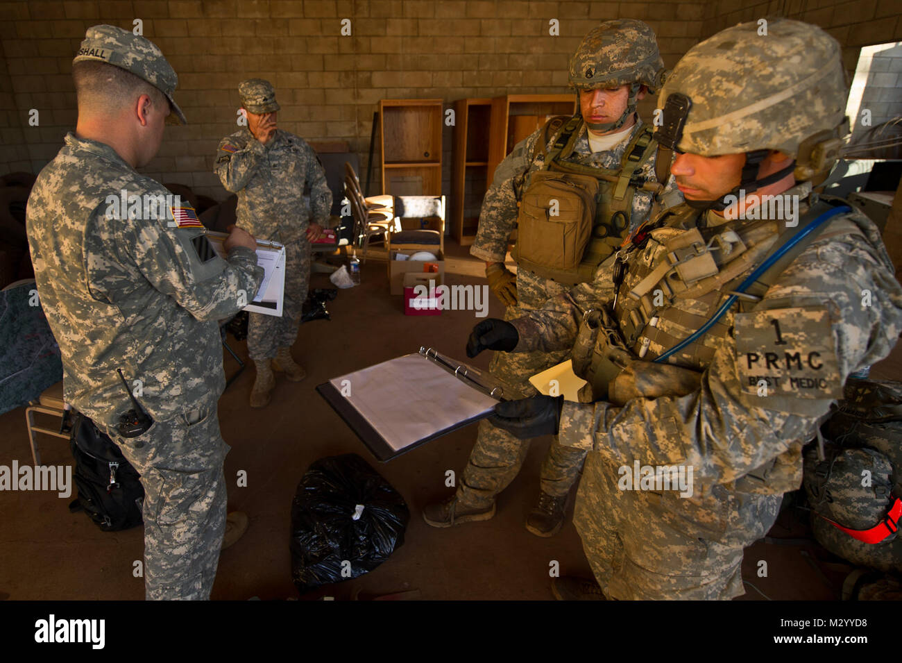 U.S. Army Staff Sgt. David Marshall conduct a pre-mission brief for ...