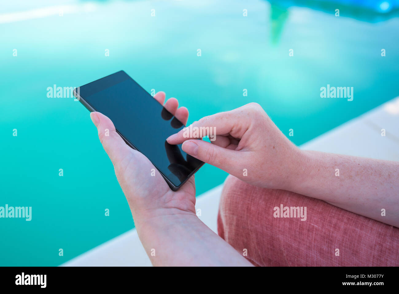 Woman smartphone swimming pool hi-res stock photography and images - Alamy