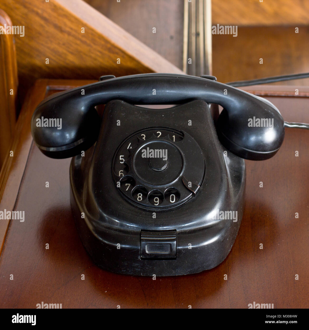 Old disk vintage dusty black phone on a desk Stock Photo - Alamy
