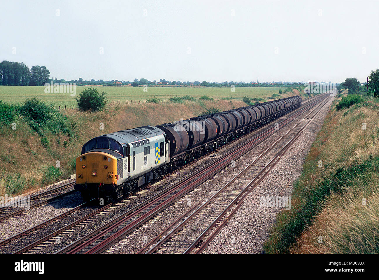 A class 37 diesel locomotive number 37709 working a train of loaded ...
