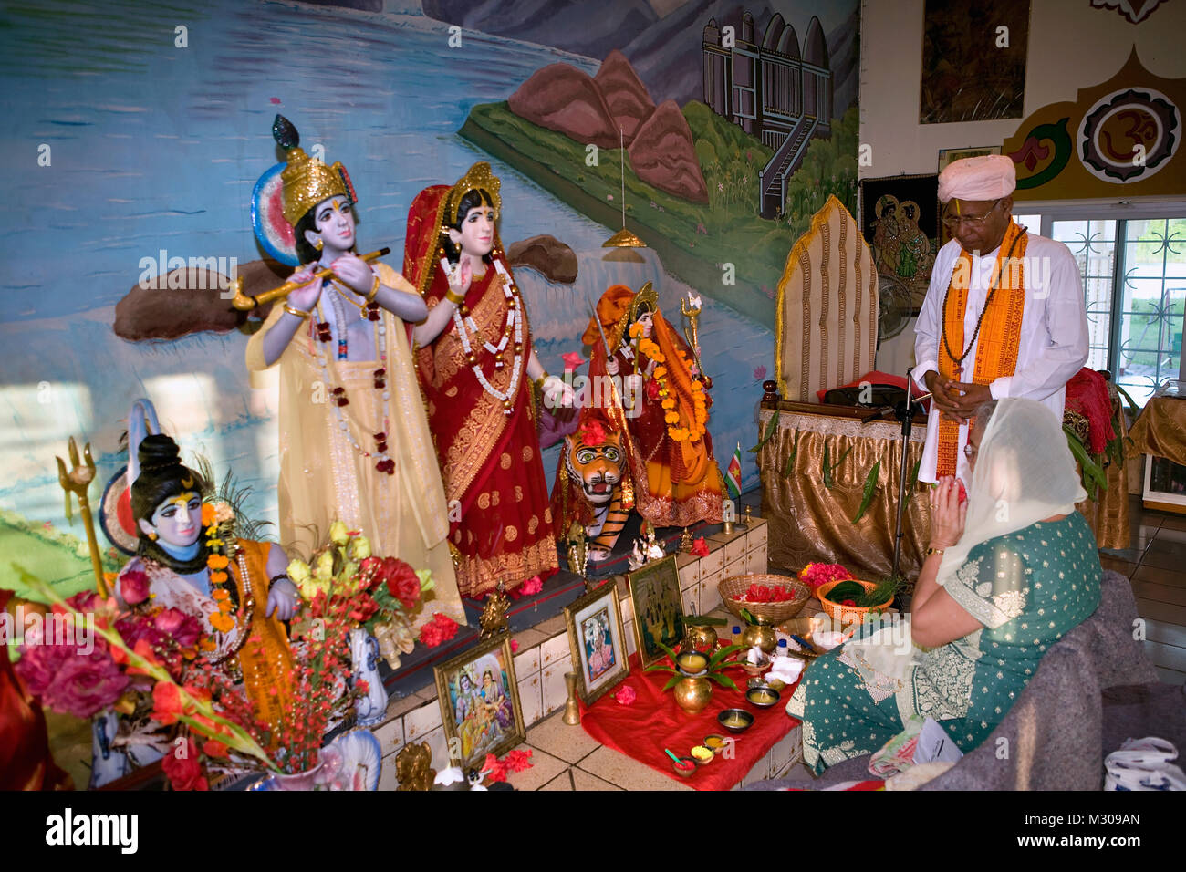 Suriname, Paramaribo, Hindu temple or mandir. Woman and pandit or hindu ...