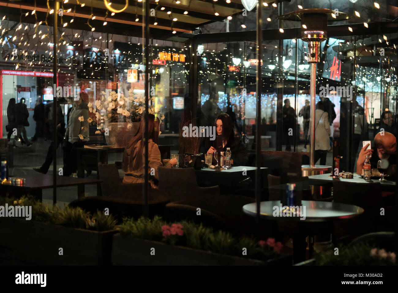 People sitting at night in a restaurant in Vitosha Boulevard the main commercial street in the ...