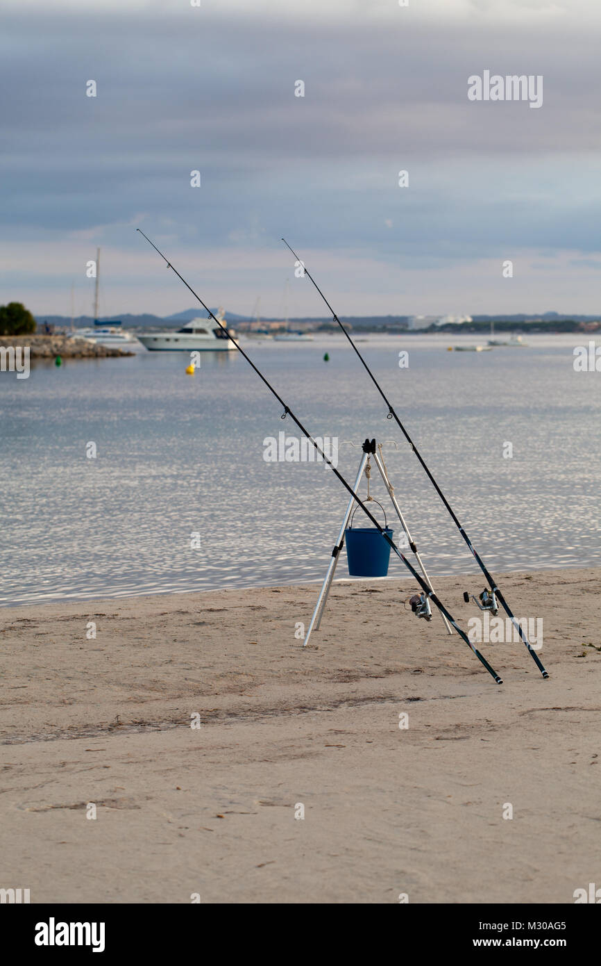 Two fishing rods at the beach in summer Stock Photo - Alamy