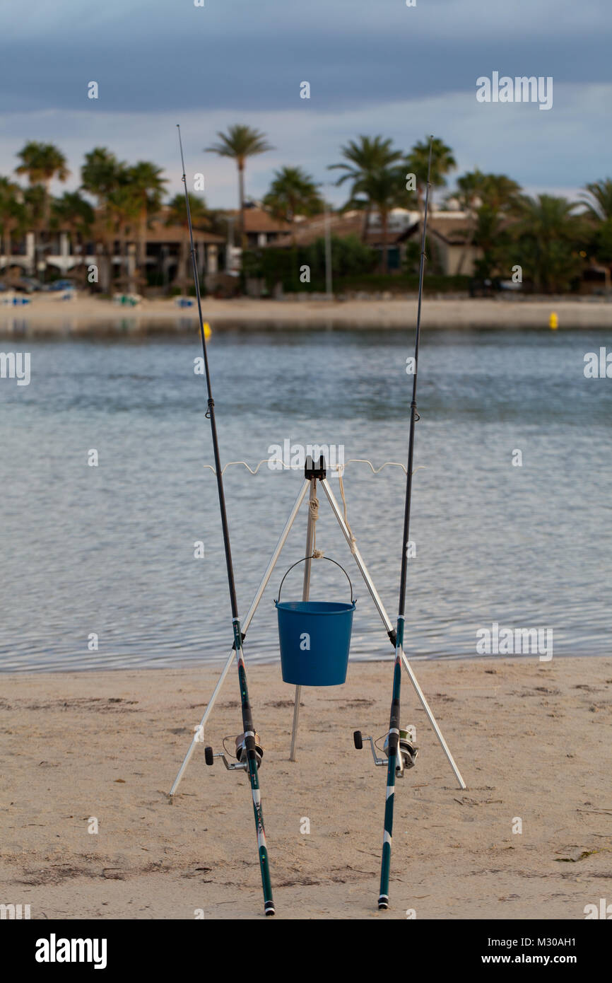 Two fishing rods at the beach in summer Stock Photo - Alamy
