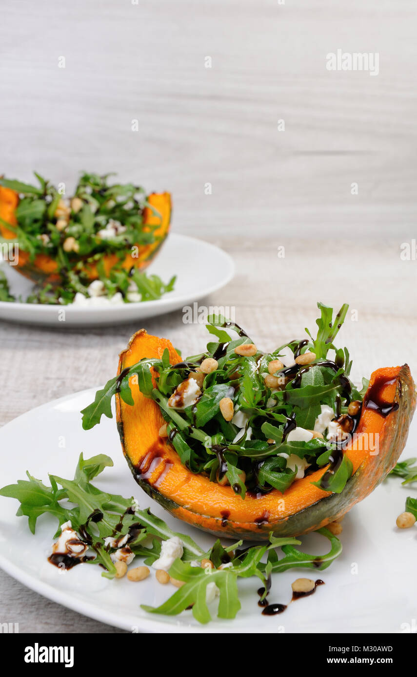 arugula serving on wedges of baked pumpkin seasoned with goat cheese ...