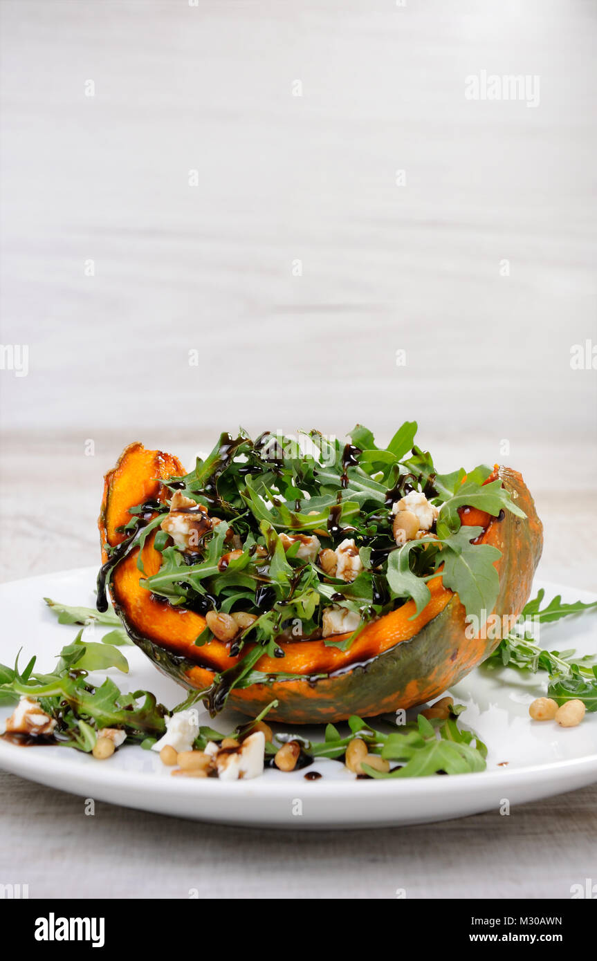 arugula serving on wedges of baked pumpkin seasoned with goat cheese ...