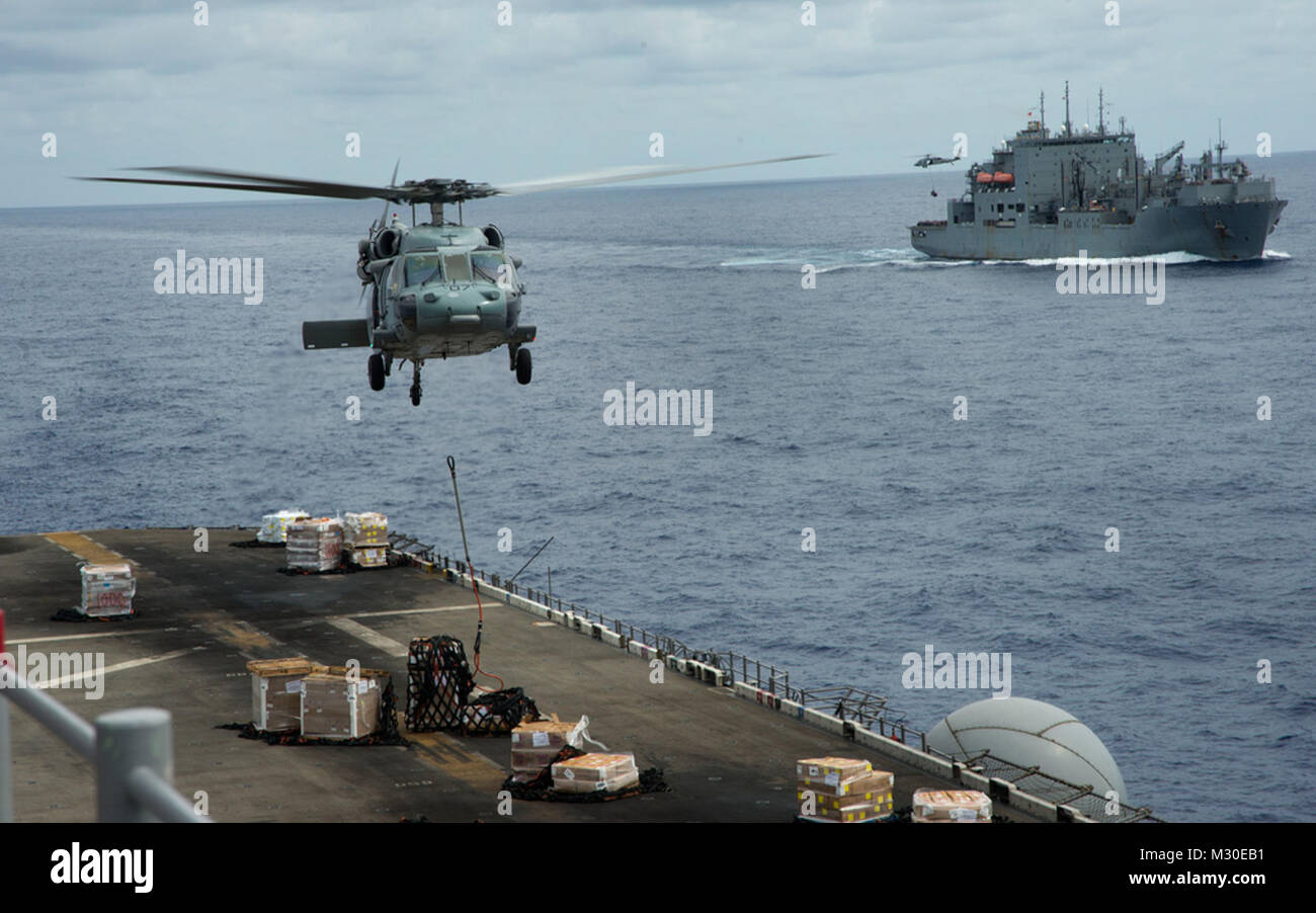 MH-60S Sea Hawk drops supplies on the flight deck aboard ship USS ...